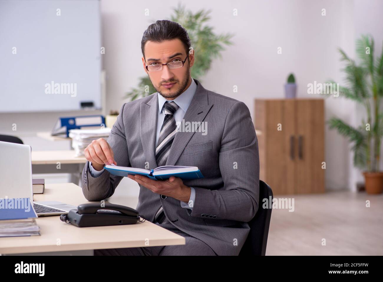 Male employee working in the office Stock Photo - Alamy