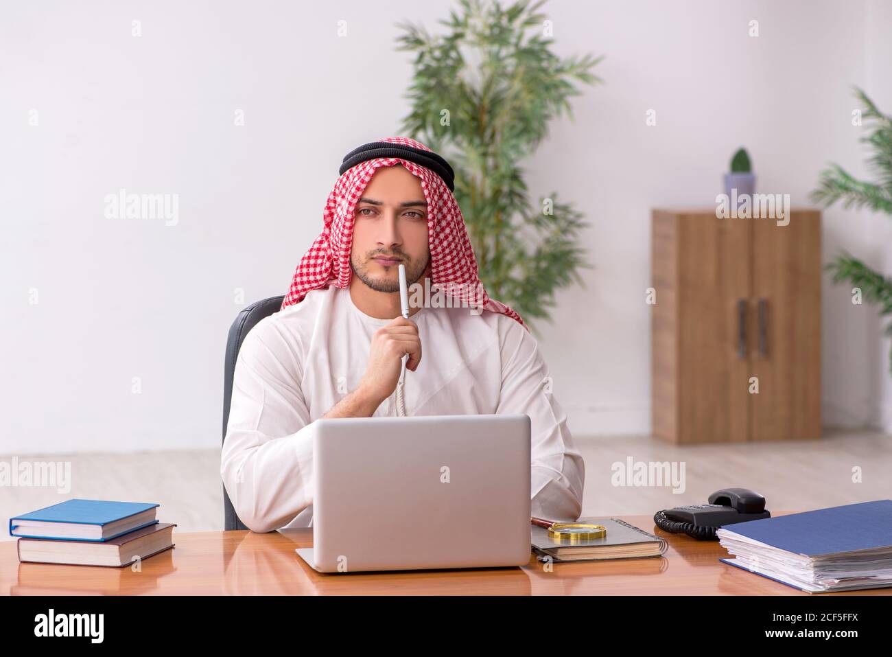 Male arab employee working in the office Stock Photo - Alamy