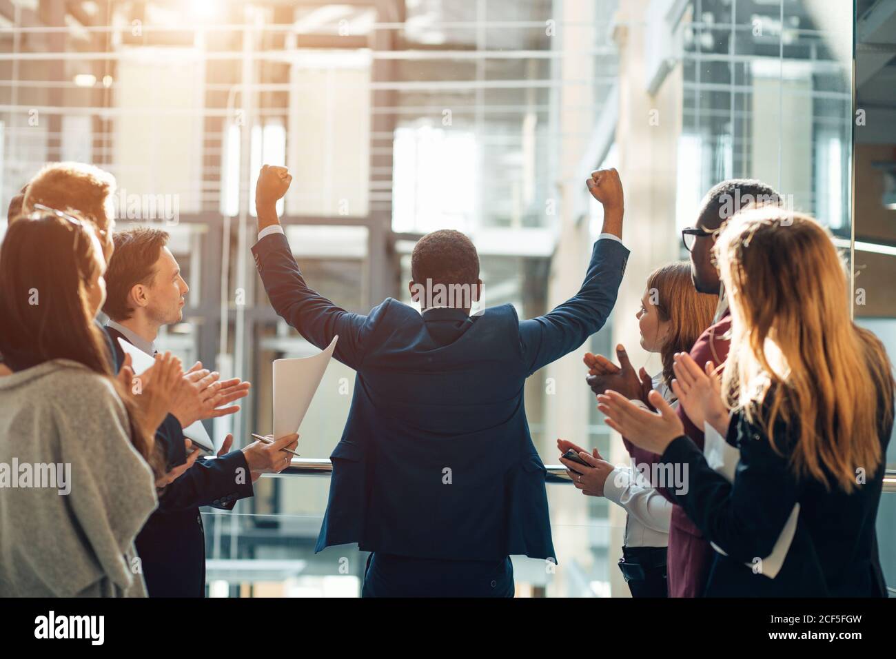 Business team celebrating triumph arms hi-res stock photography and ...