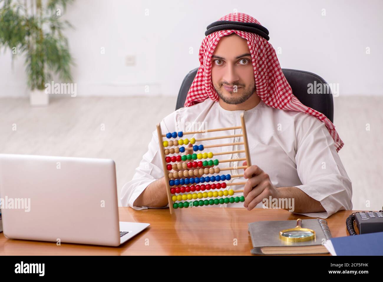 Male arab employee working in the office Stock Photo - Alamy