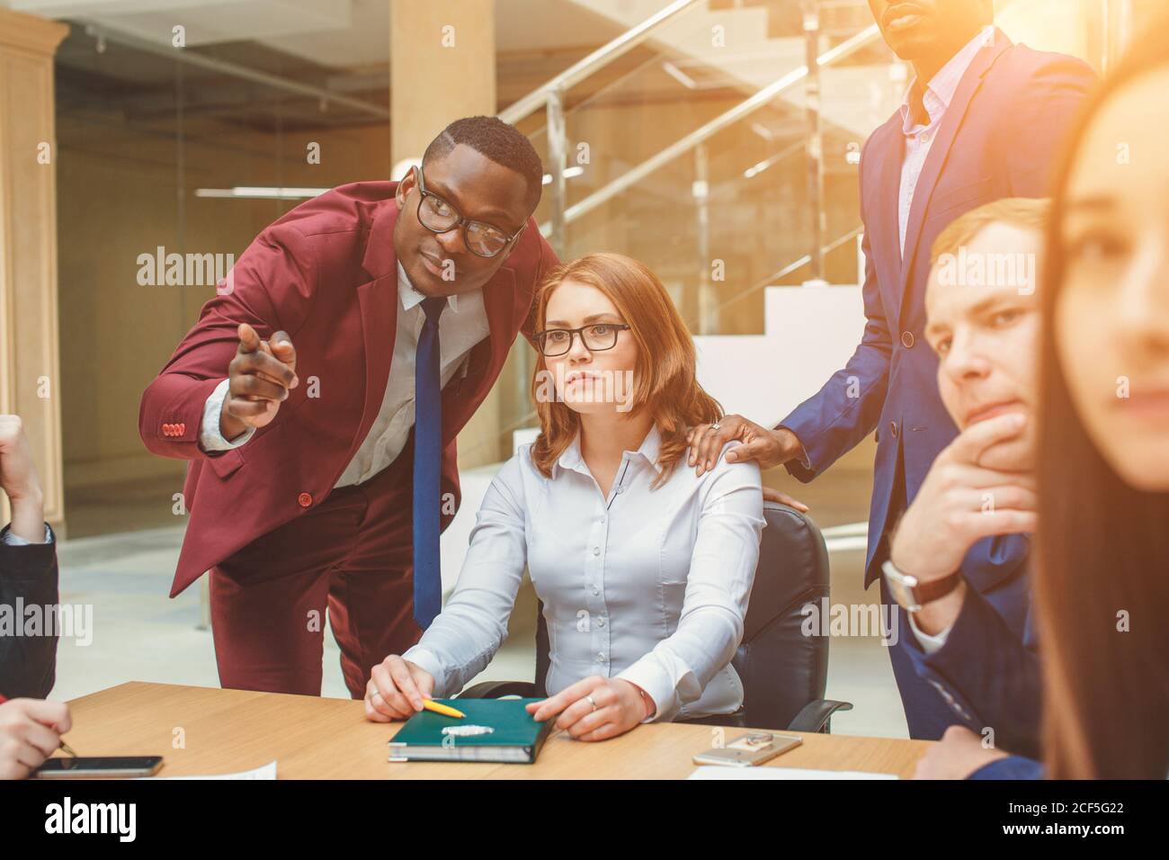 female boss talking to business group at night office background Stock ...