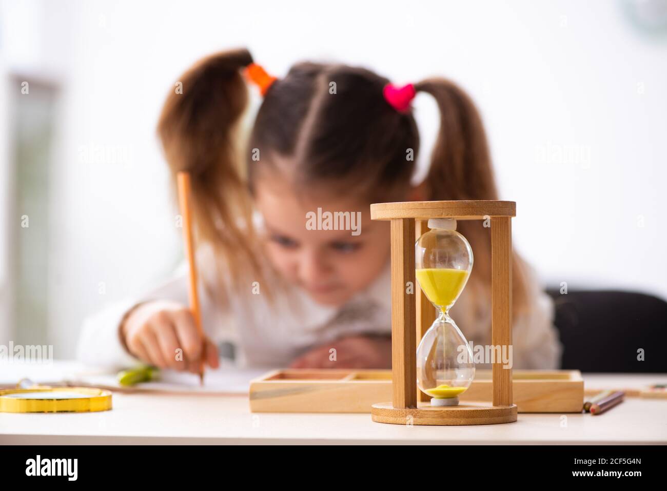 Small girl in the time management concept Stock Photo - Alamy