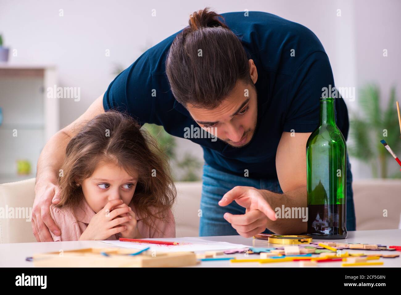 Drunk father and little girl at home Stock Photo - Alamy