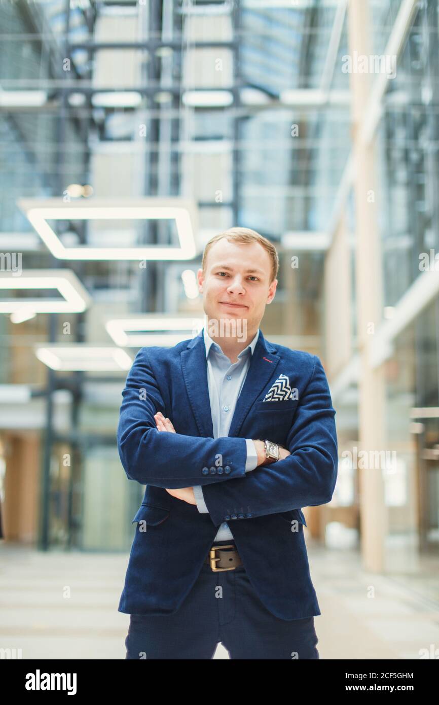 Portrait of a handsome CEO smiling at modern office Stock Photo - Alamy