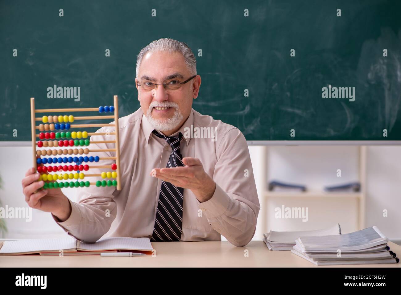 Old experienced teacher in the classroom Stock Photo - Alamy