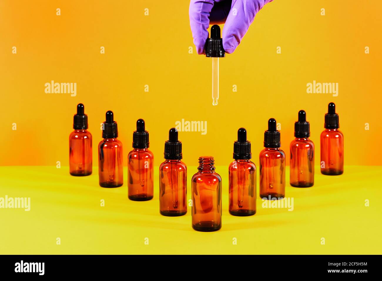 Hand holding dropper bottles hi-res stock photography and images - Alamy