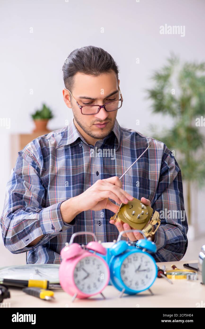 Young watchmaker working in the workshop Stock Photo - Alamy