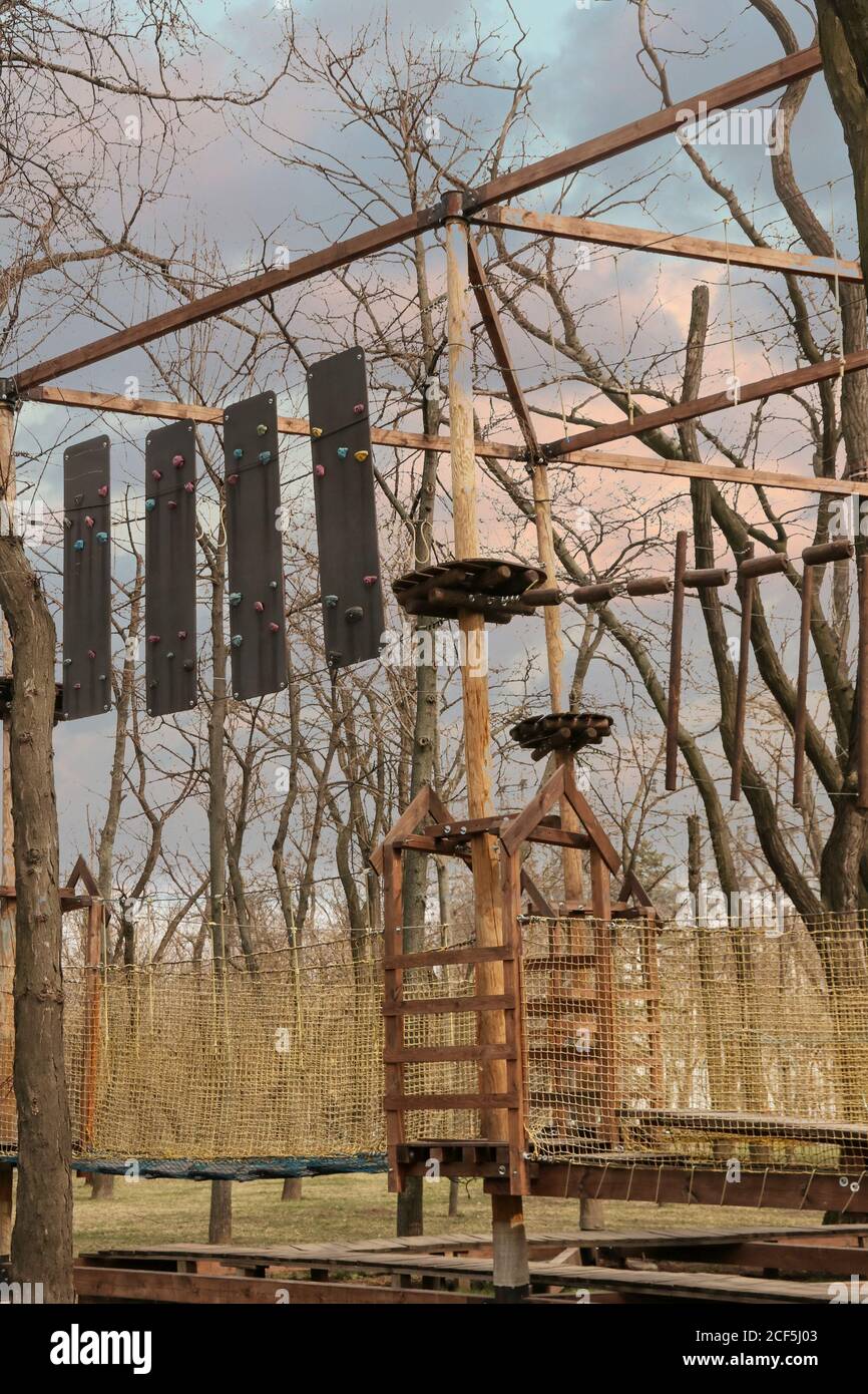 Climbing wall in an amusement park for children and adults. Wooden ...