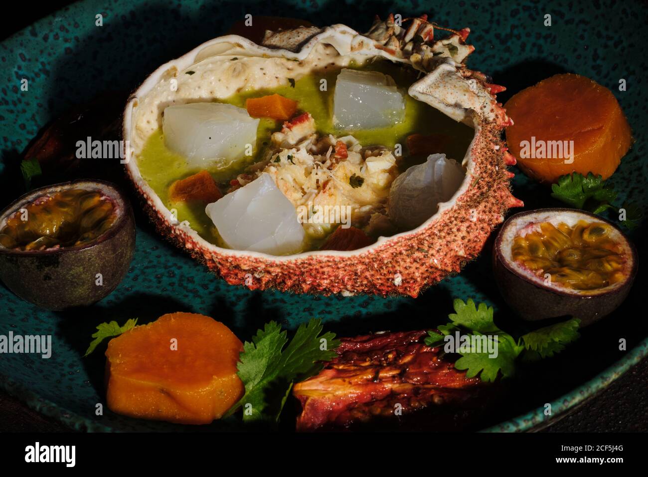 Closeup savory cheviche served in spider crab shell with arthropod meat ...