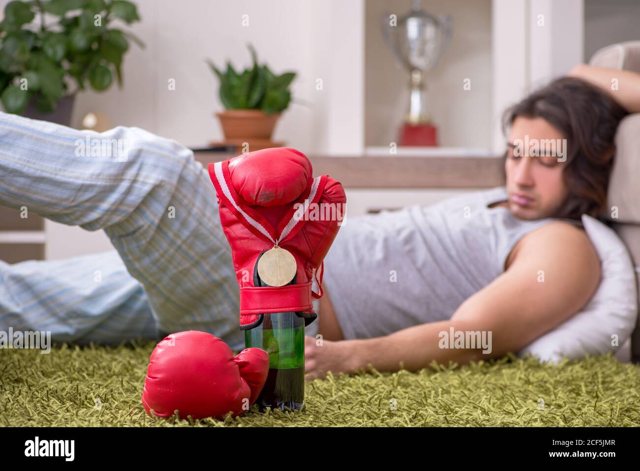 Ex-champion boxer suffering from alcoholism at home Stock Photo - Alamy