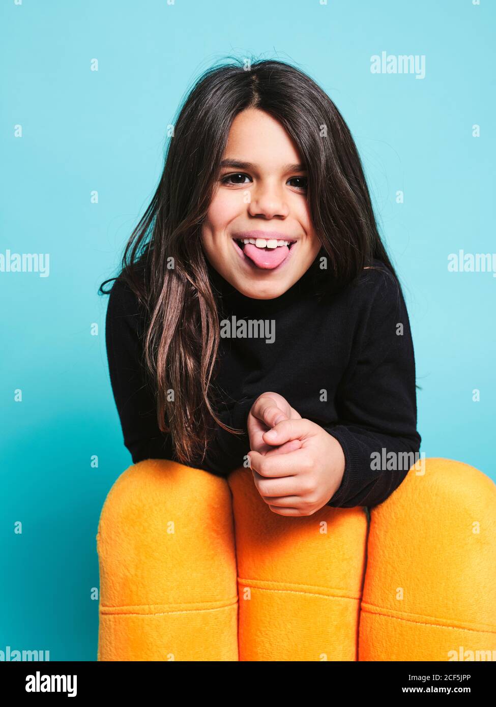 Happy preteen girl in black casual clothes smiling sticking tongue out ... Happy preteen girl in black casual clothes smiling sticking tongue out ...