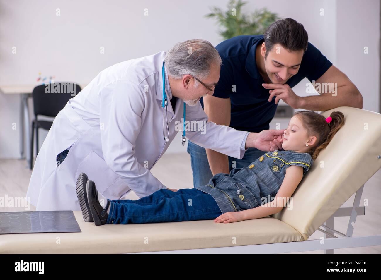 Young father and his daughter visiting old doctor Stock Photo - Alamy