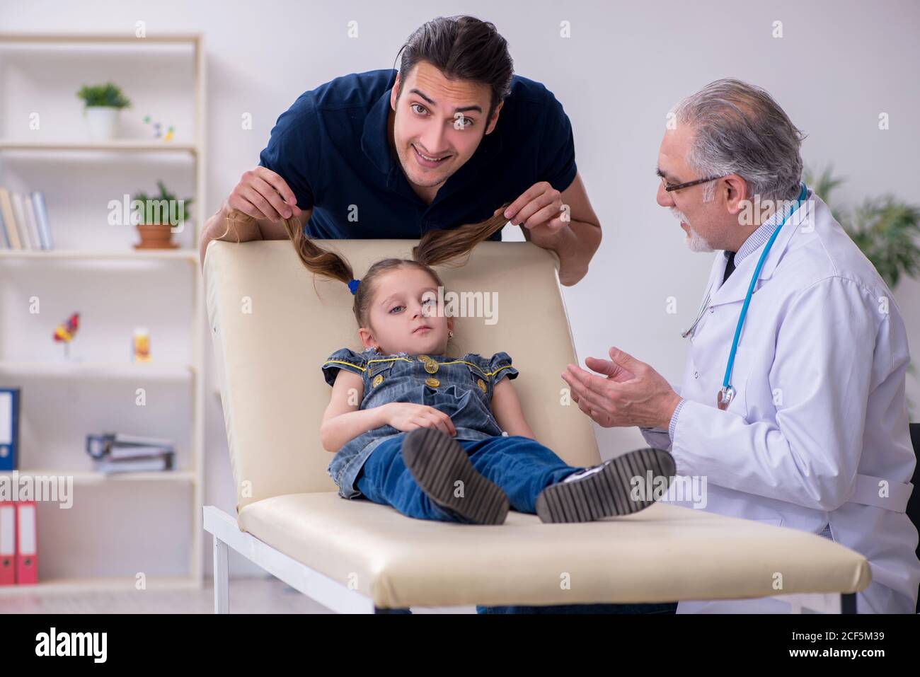Young father and his daughter visiting old doctor Stock Photo - Alamy