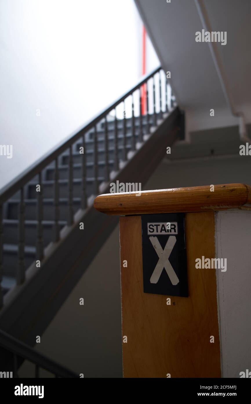 Information warning sign with Stair X inscription placed on railing of ...