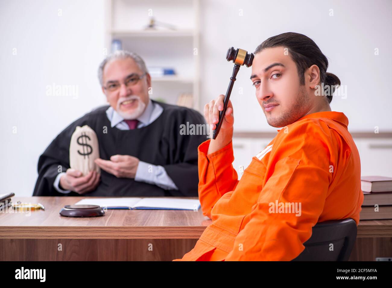 Old judge meeting with young captive in courthouse Stock Photo - Alamy