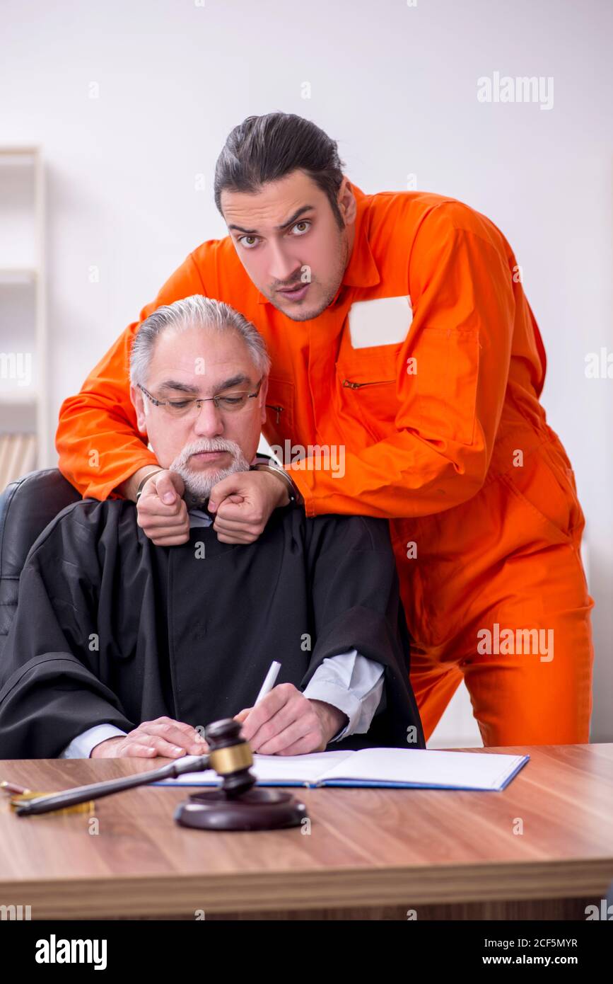 Old judge meeting with young captive in courthouse Stock Photo - Alamy