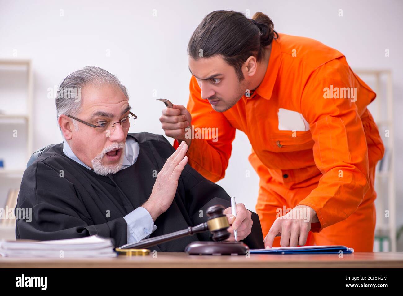 Old judge meeting with young captive in courthouse Stock Photo - Alamy