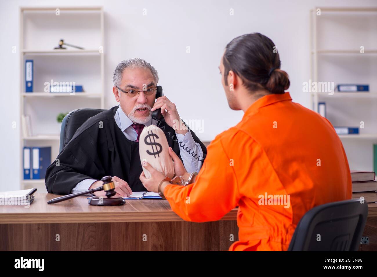 Old judge meeting with young captive in courthouse Stock Photo - Alamy