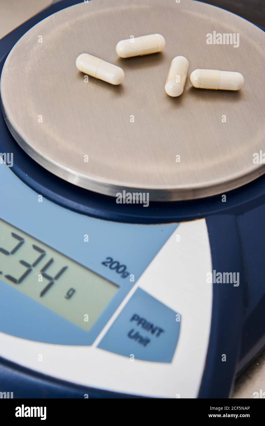 Weighing of capsules and pills in precision scales of medicine and ...