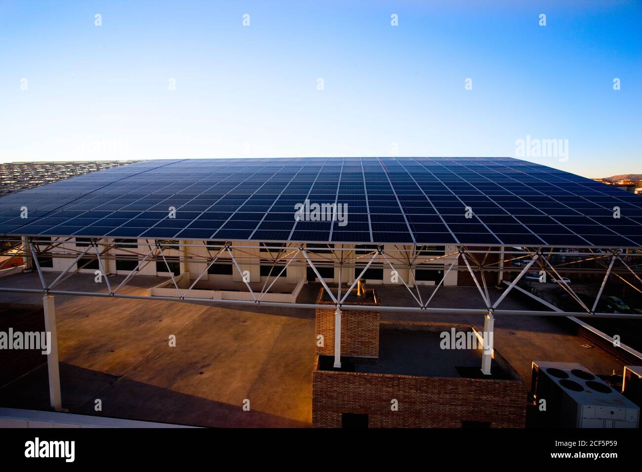 Building with roof made of solar panels Stock Photo - Alamy