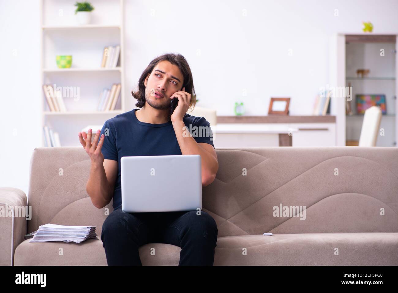 Young man employee working from home Stock Photo - Alamy