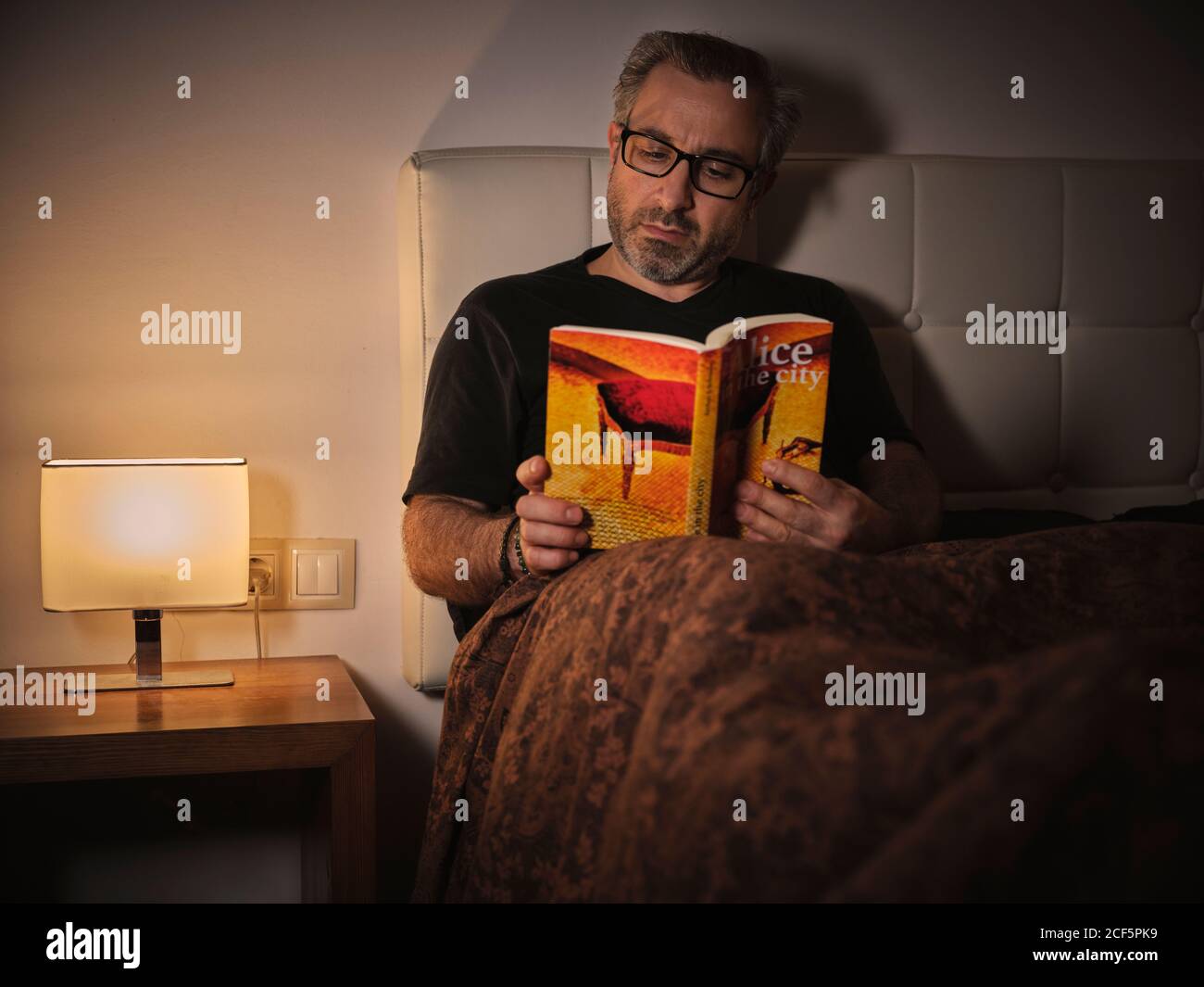 Sleeping reading book relaxed bed hi-res stock photography and images ...