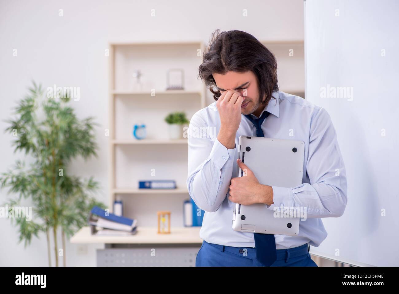 Young man employee presenting in the office Stock Photo - Alamy