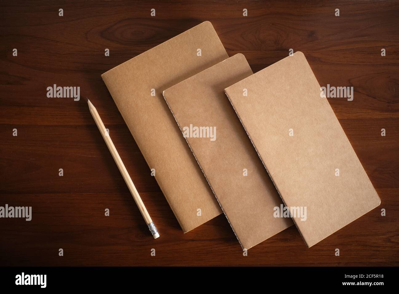 cool traditional notebooks on wooden table and pencil Stock Photo - Alamy