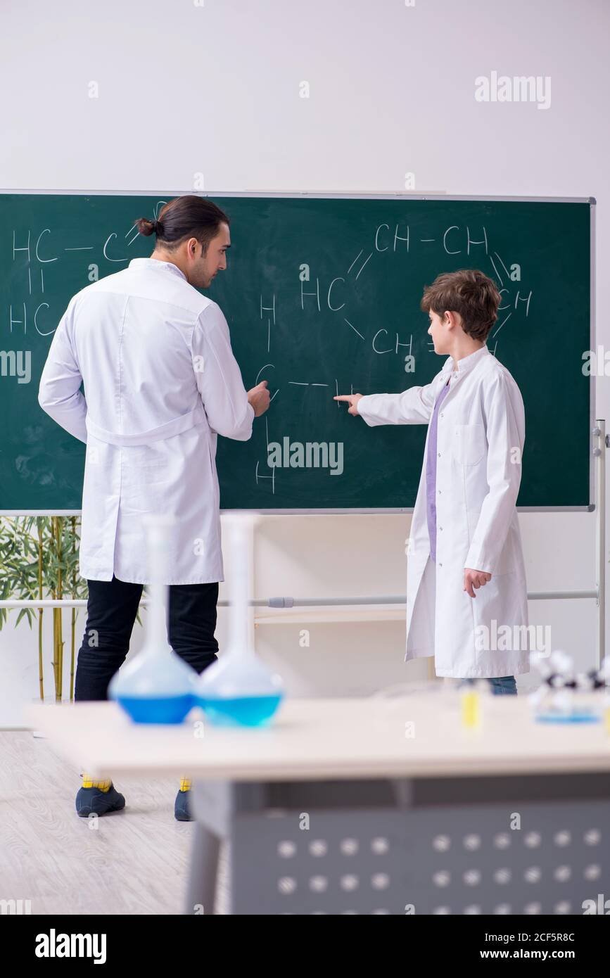 Young chemistry teacher and schoolboy in classroom Stock Photo - Alamy