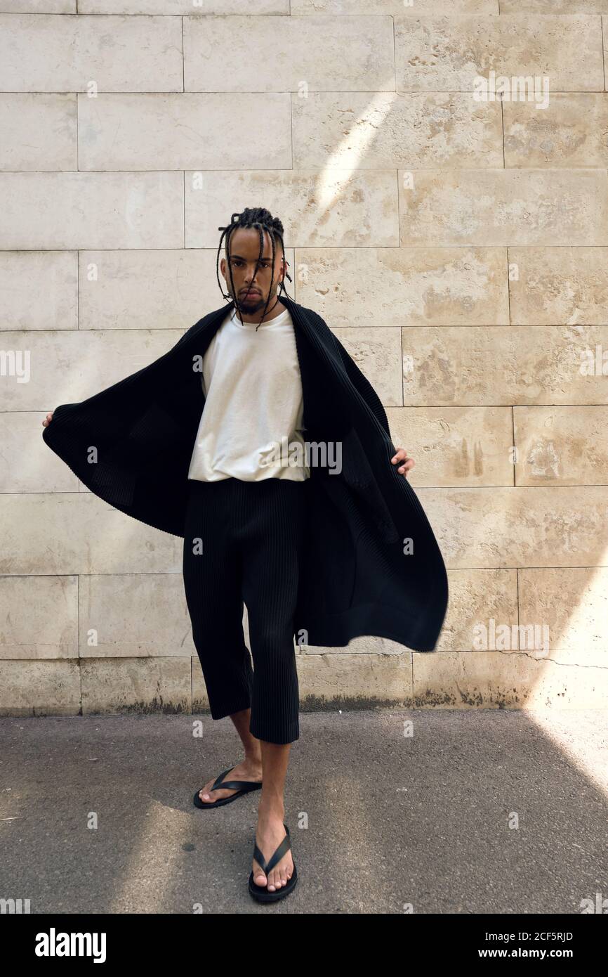 Fashionable young African American male in stylish outfit posing in ...