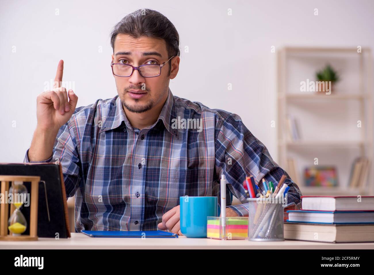 Young student sitting in the classroom Stock Photo - Alamy