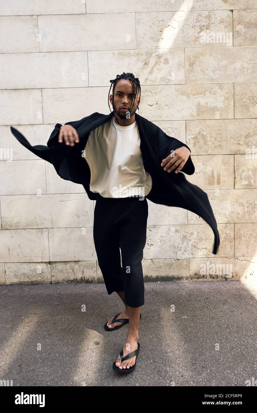 Fashionable young African American male in stylish outfit posing in ...