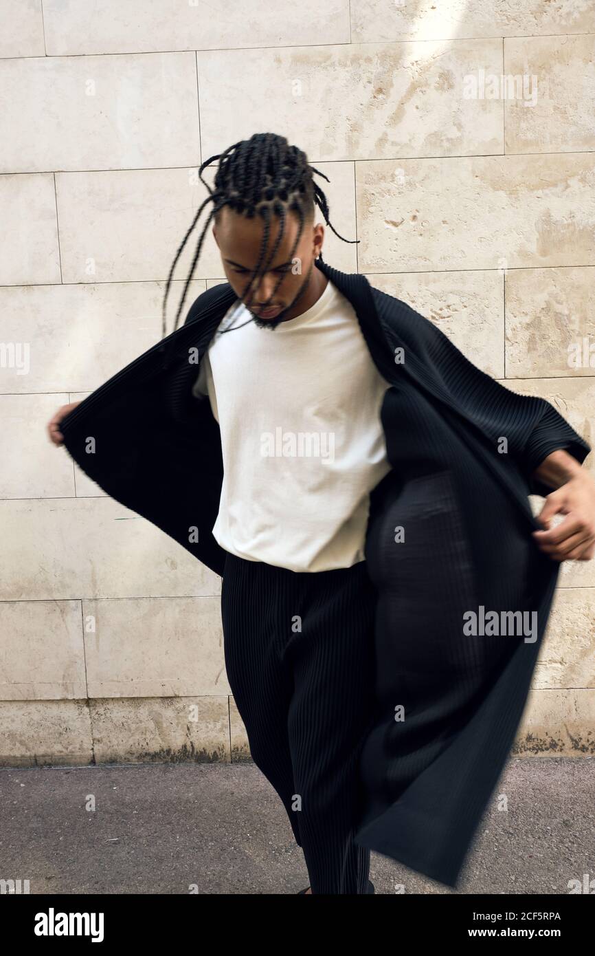 Fashionable young African American male in stylish outfit posing in ...