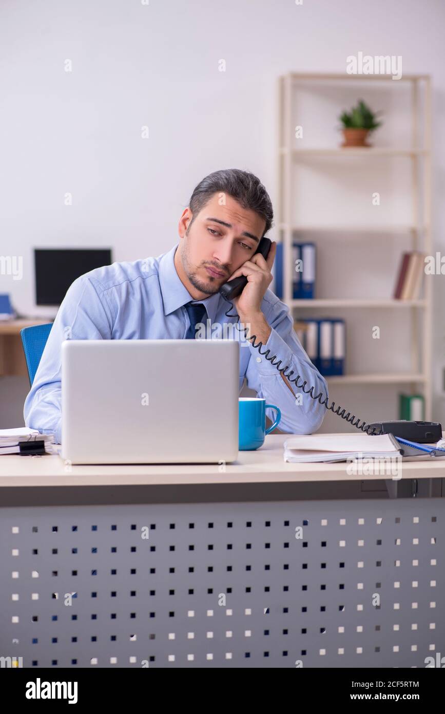 Sick male employee suffering at the workplace Stock Photo - Alamy