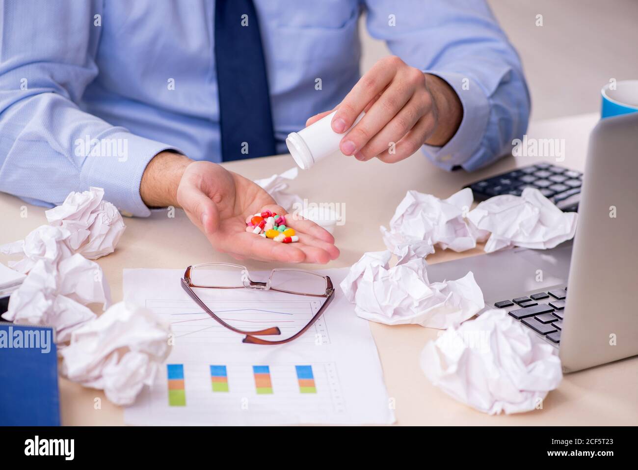 Sick male employee suffering at the workplace Stock Photo - Alamy
