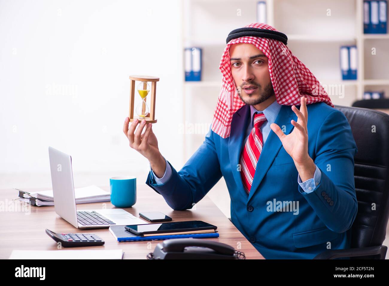 Young male arab employee working in the office Stock Photo - Alamy
