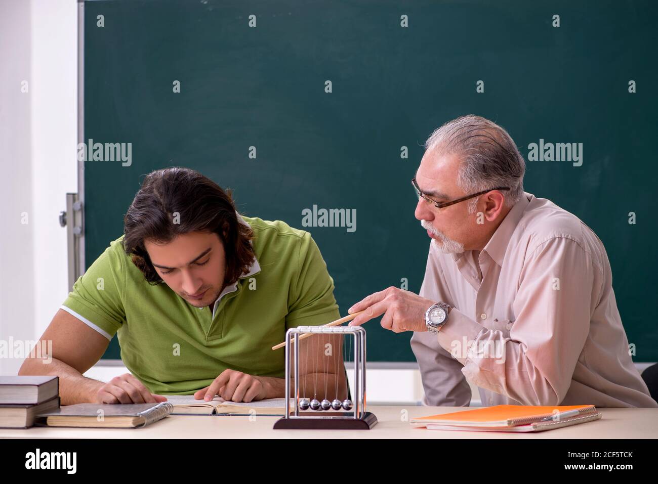 Old professor physicist and student in the classroom Stock Photo - Alamy