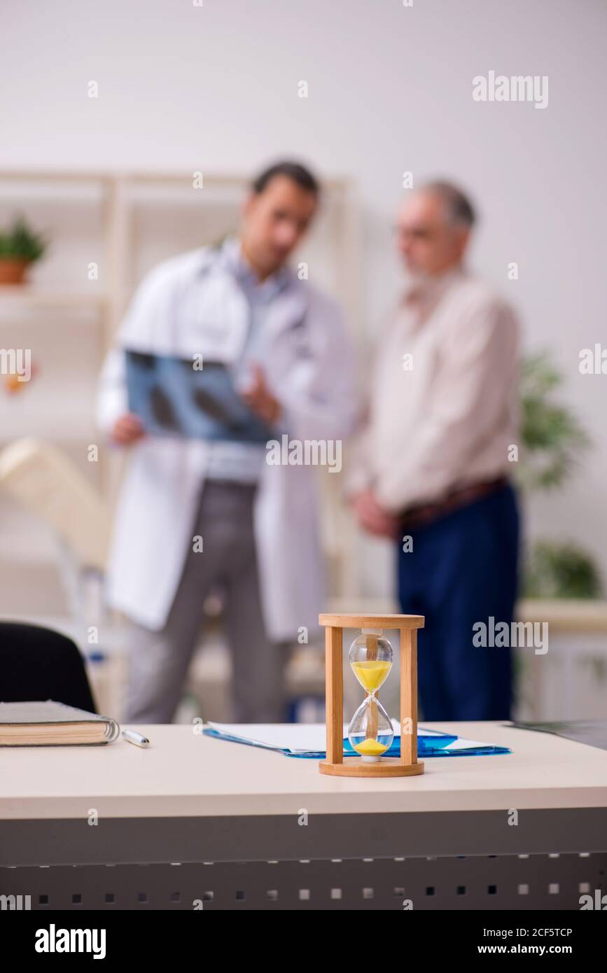 Male patient visiting doctor radiologist in time management concept ...