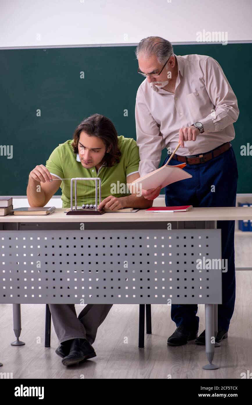 Old professor physicist and student in the classroom Stock Photo - Alamy
