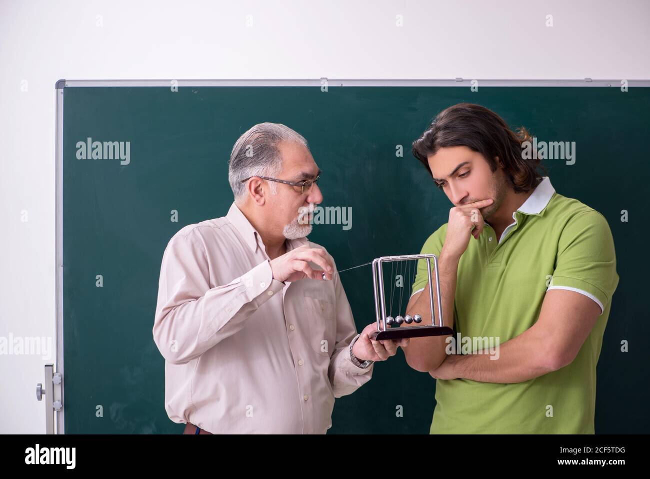 Old professor physicist and student in the classroom Stock Photo - Alamy