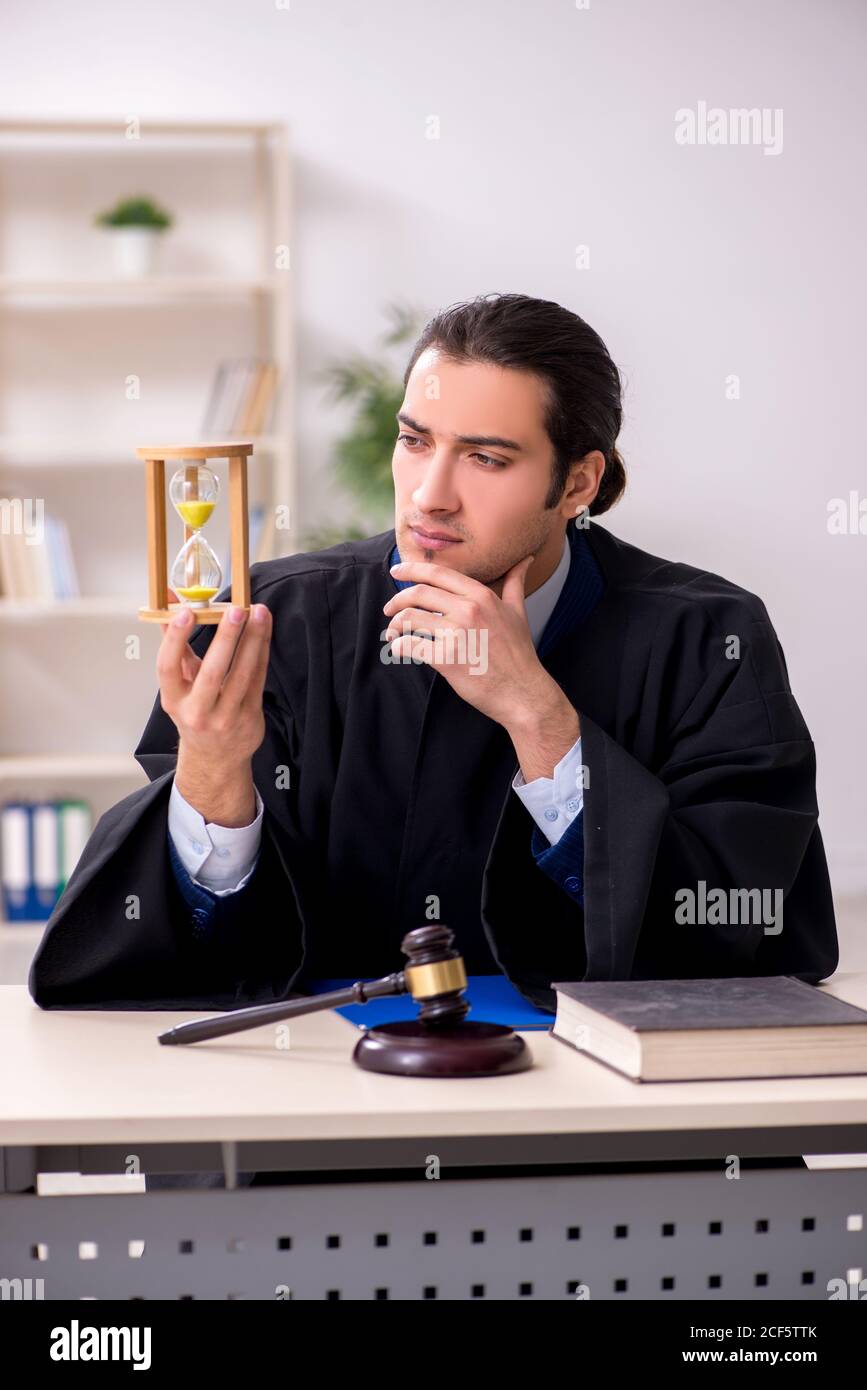 Young judge in time management concept Stock Photo - Alamy