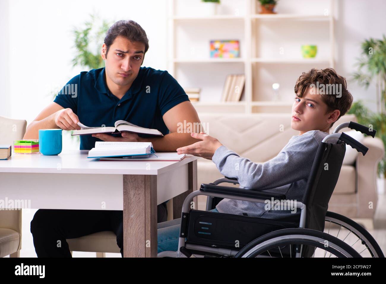 Father and disabled son in the education concept Stock Photo - Alamy
