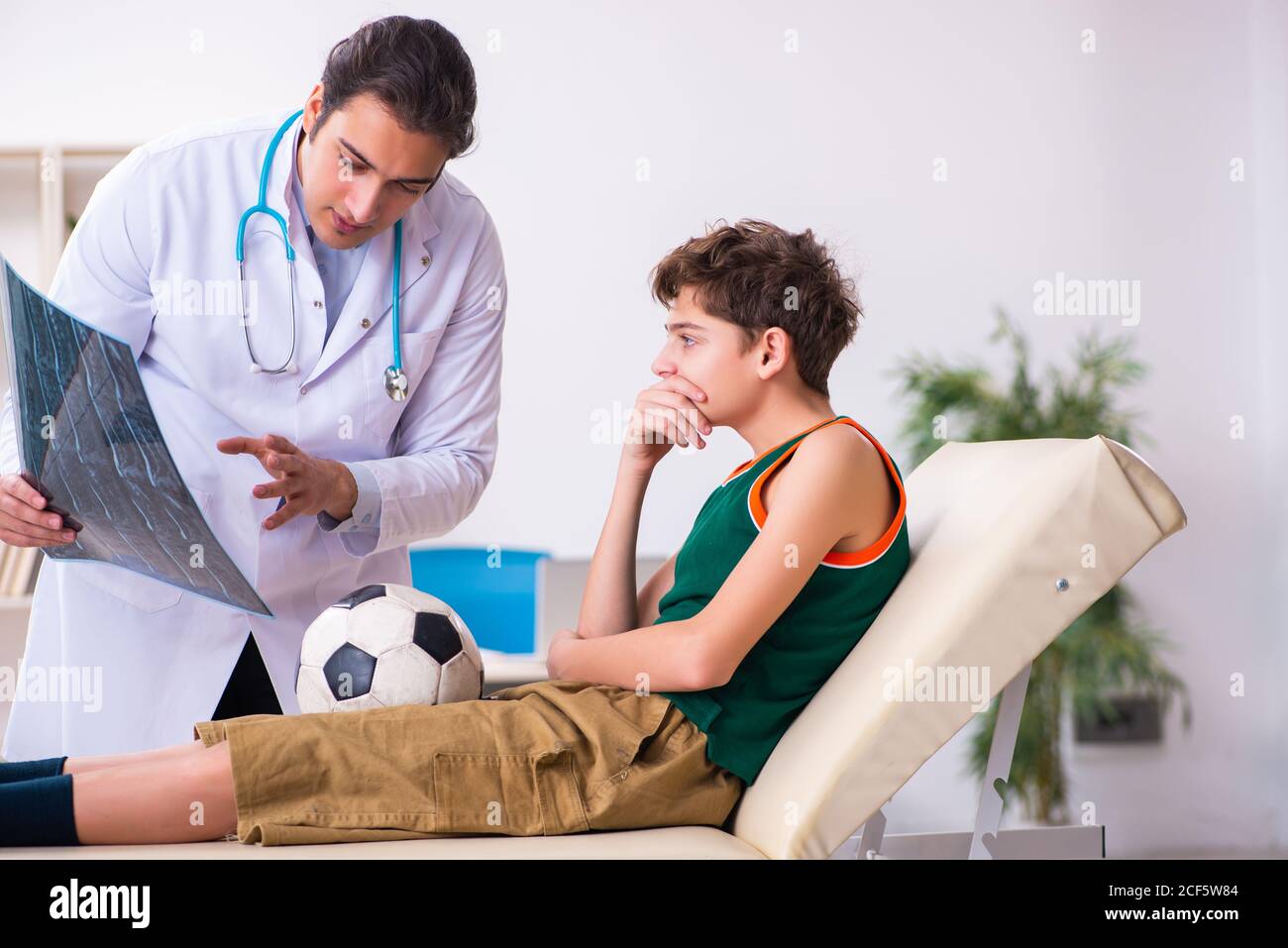 Sick boy visiting young doctor pediatrician Stock Photo - Alamy