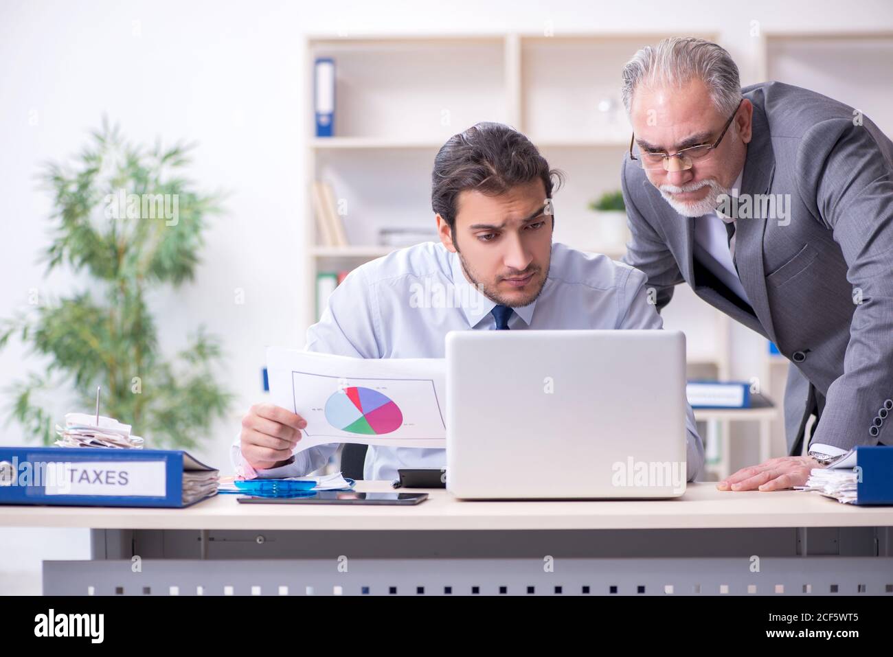 The two accountants working in the office Stock Photo - Alamy