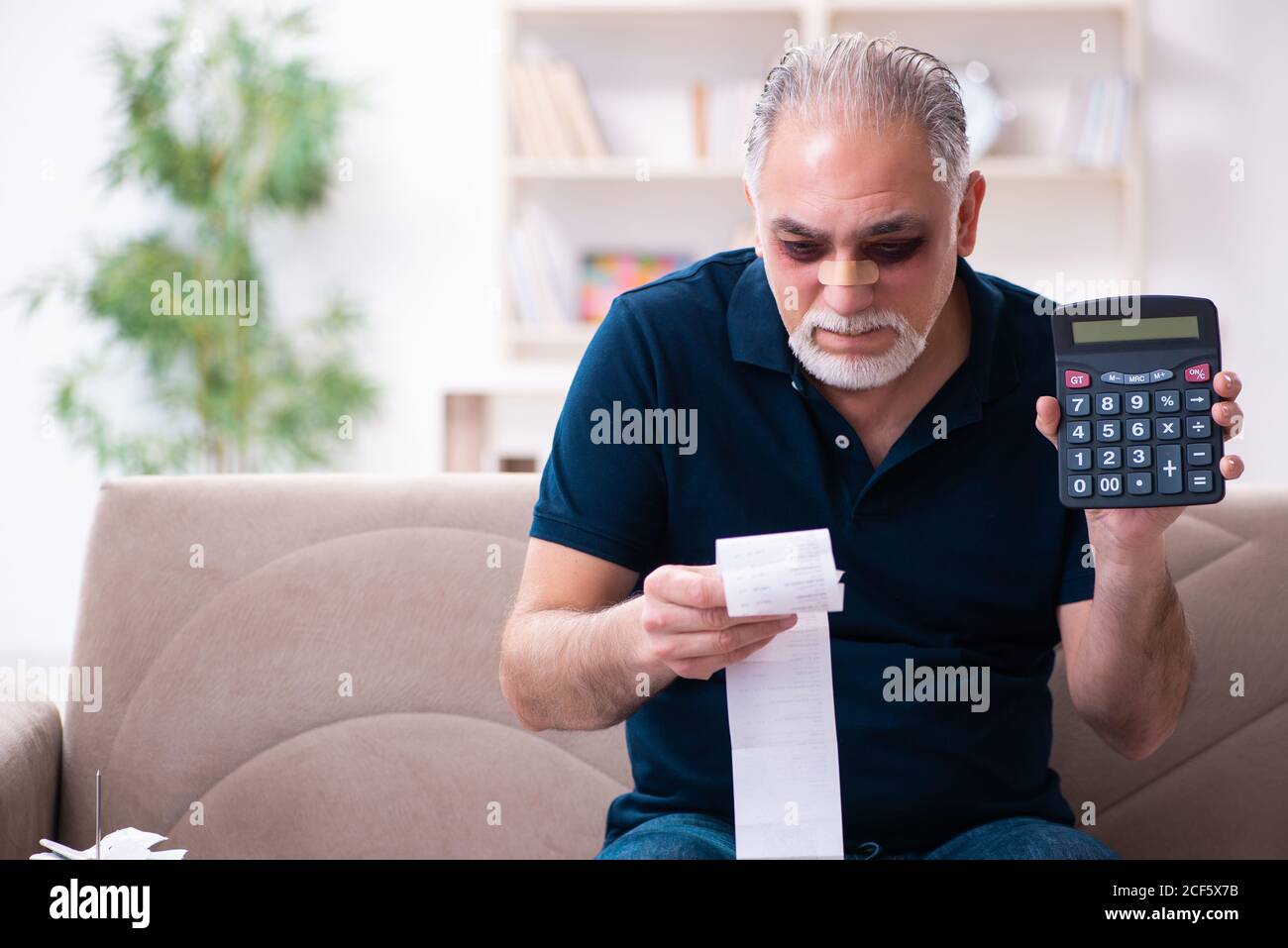 Old man in budget planning concept Stock Photo - Alamy