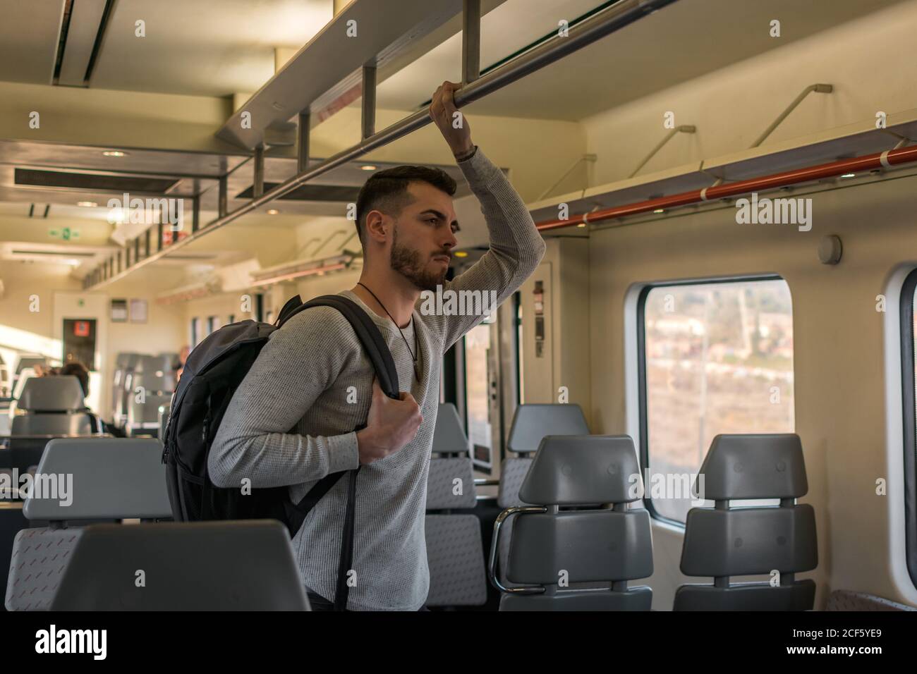 Focused young male passenger riding metro in daytime Stock Photo - Alamy