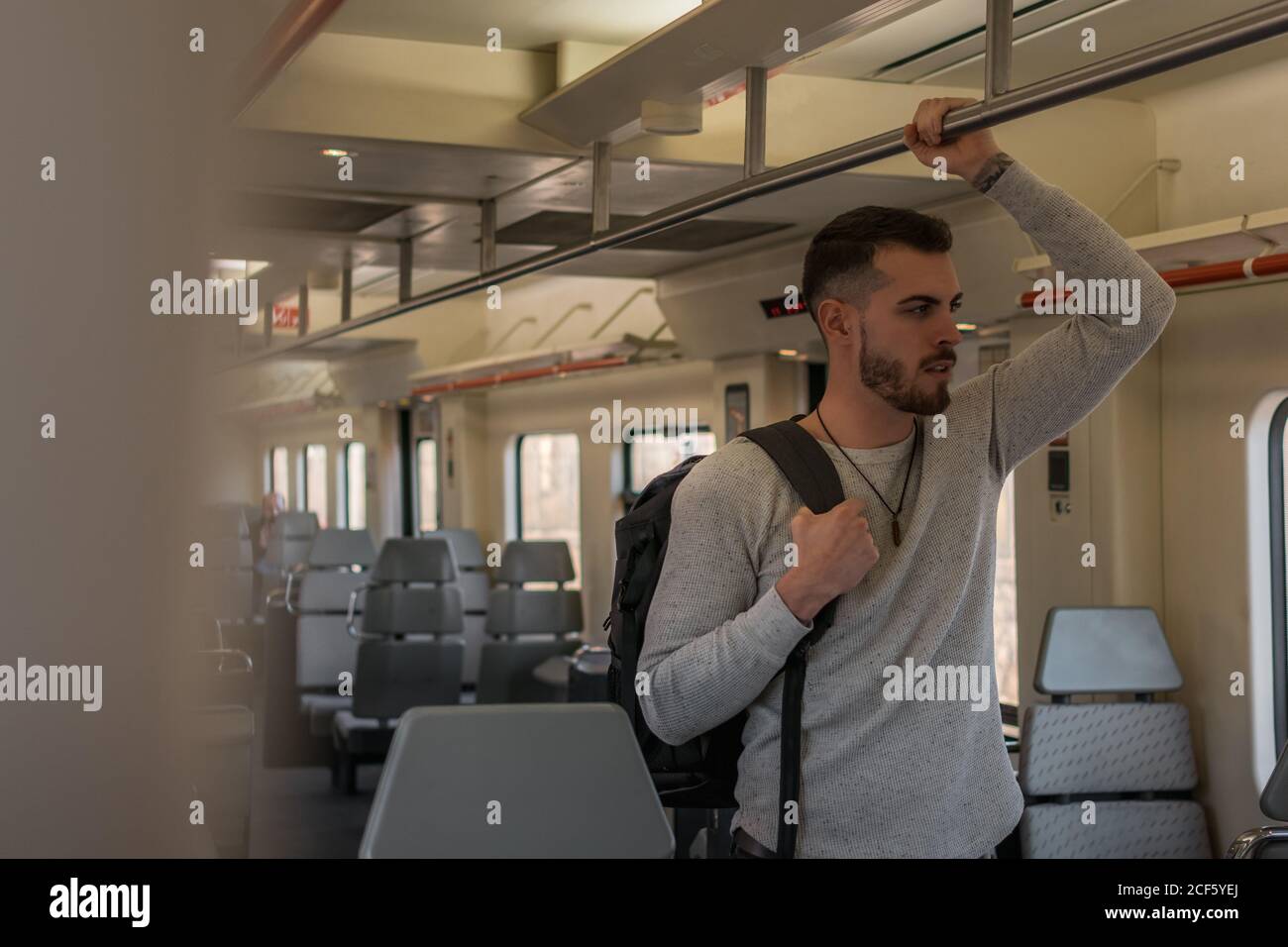Focused young male passenger riding metro in daytime Stock Photo - Alamy
