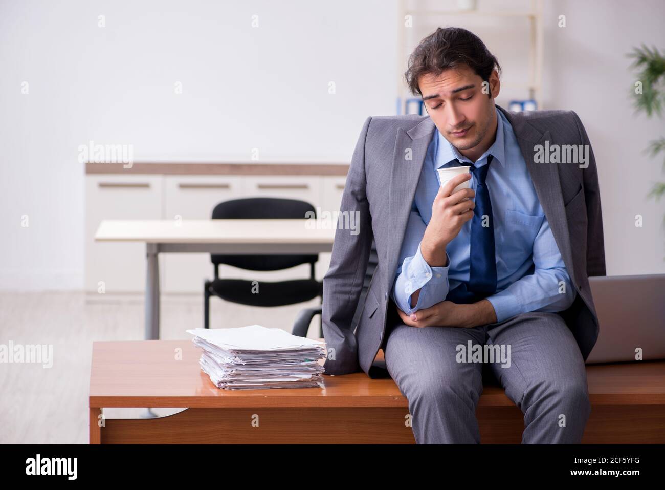 Young employee sleeping in the office Stock Photo - Alamy
