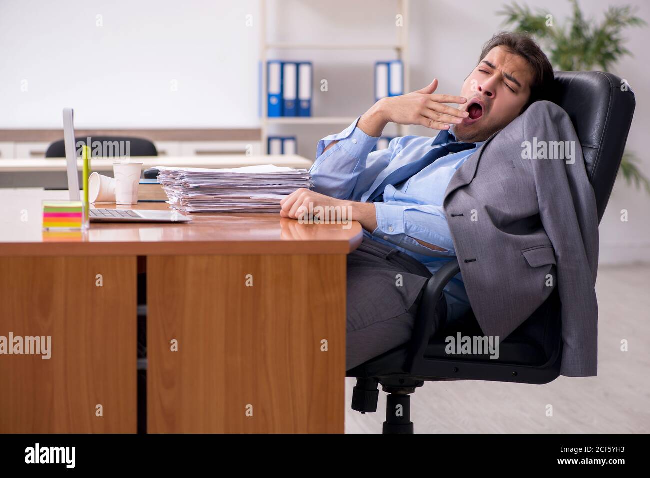 Young employee sleeping in the office Stock Photo - Alamy