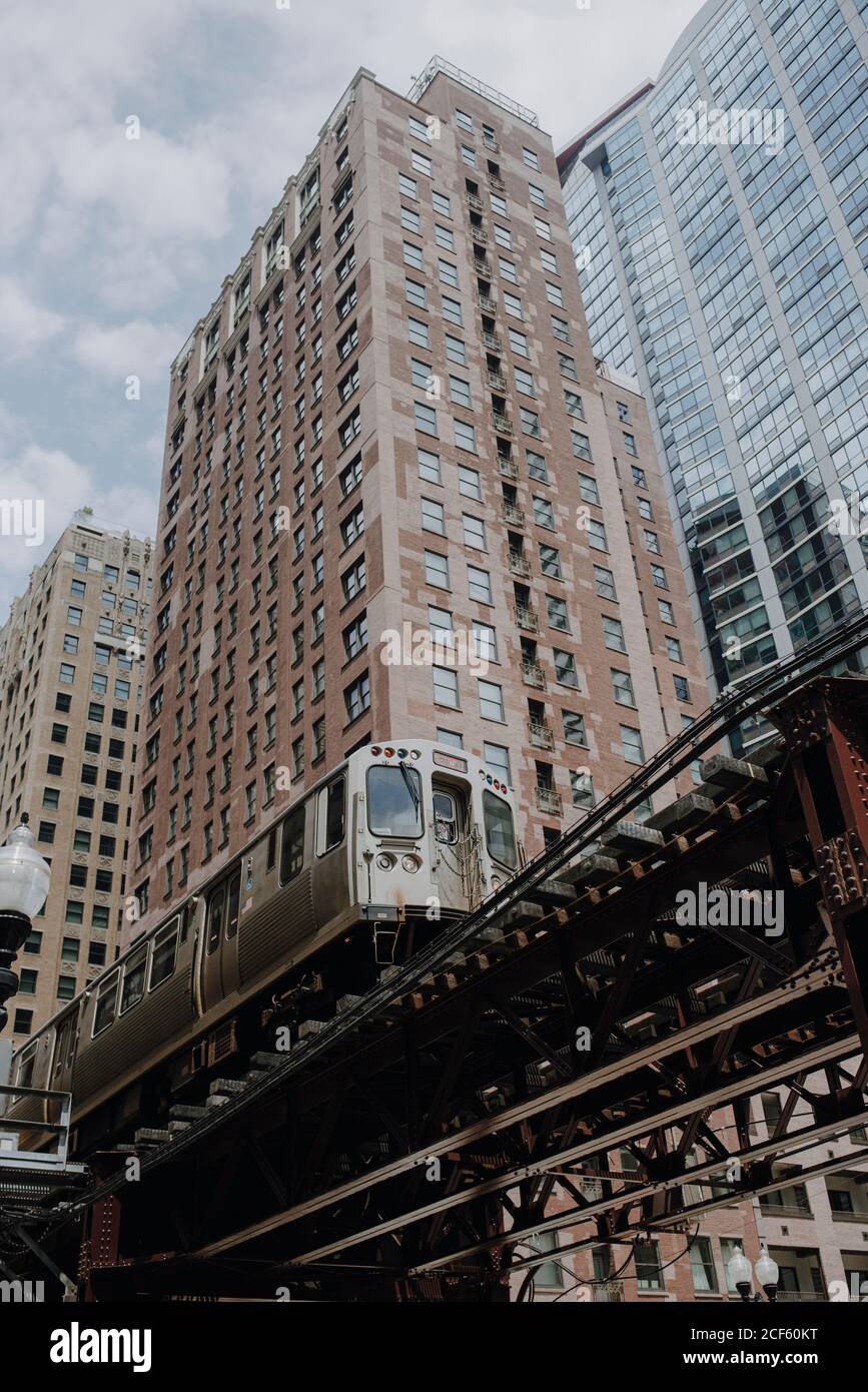Train on elevated road near modern buildings Stock Photo - Alamy